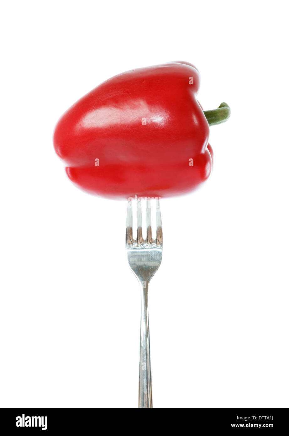 Whole red bell pepper pinned on a fork against white background Stock ...