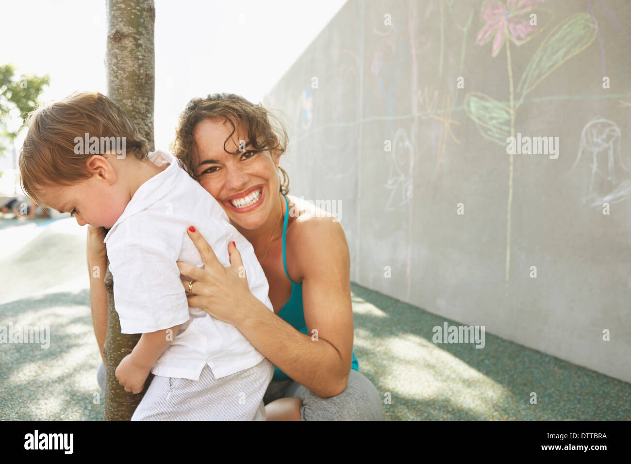 Crouching mother hugging her child hi-res stock photography and images ...