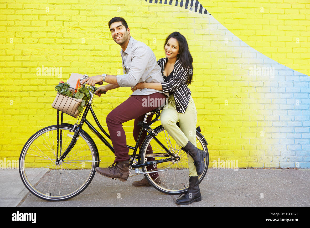 Indian couple riding bicycle on city street Stock Photo - Alamy