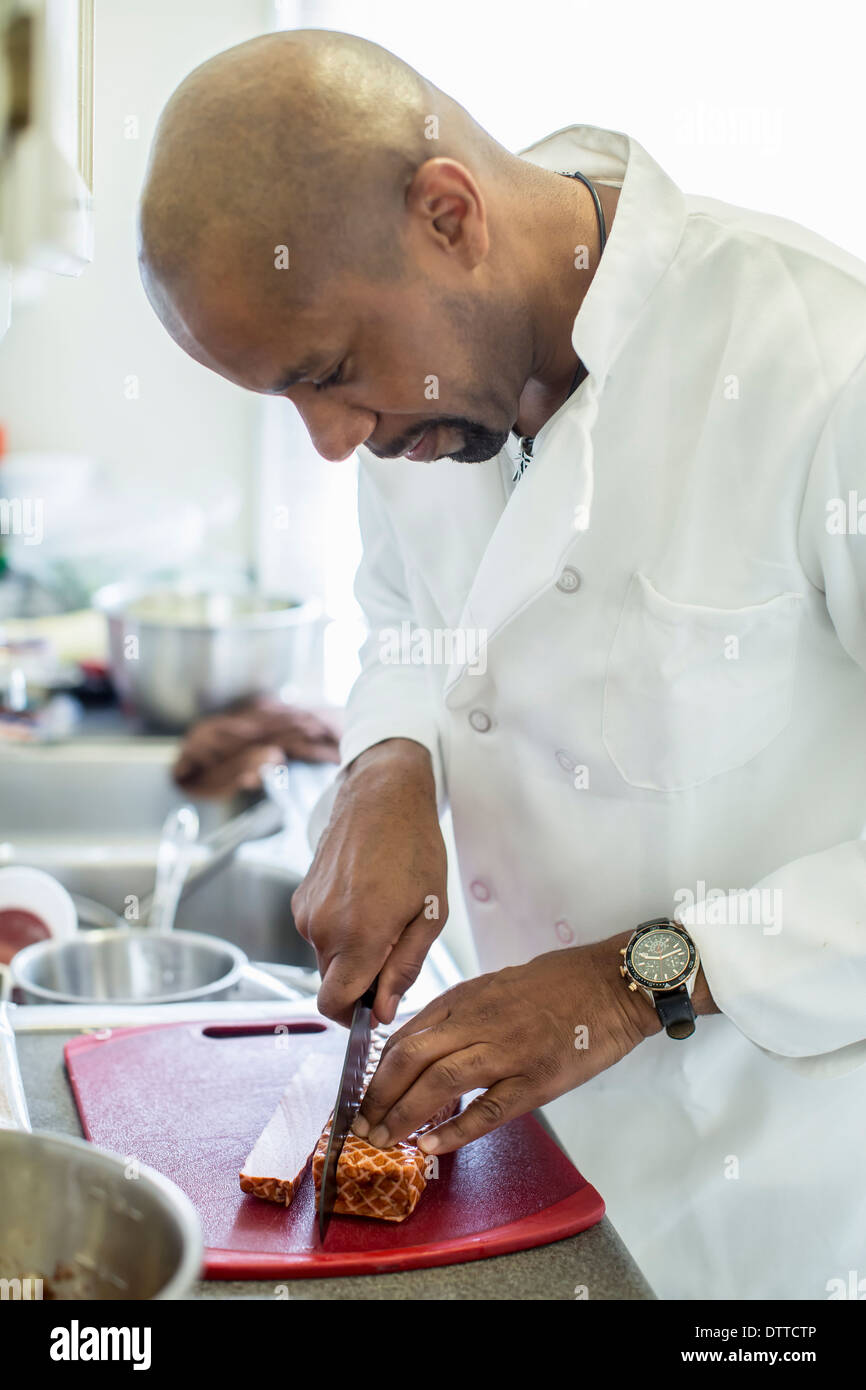 Black chef working in kitchen Stock Photo - Alamy
