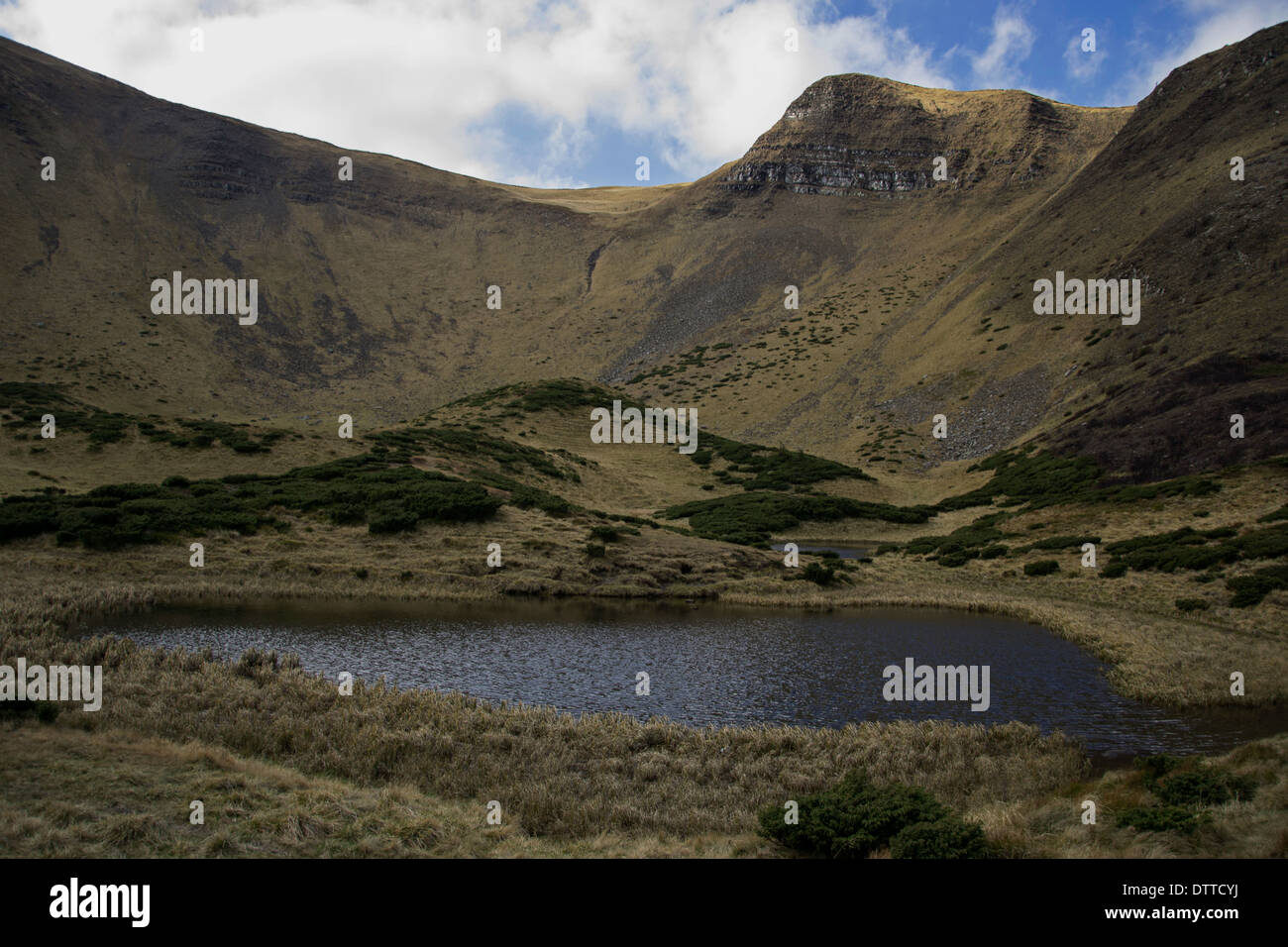 Oval lake at the foot of the mountain Stock Photo - Alamy