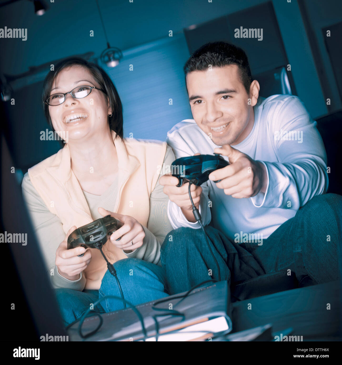 Couple playing video games together Stock Photo - Alamy
