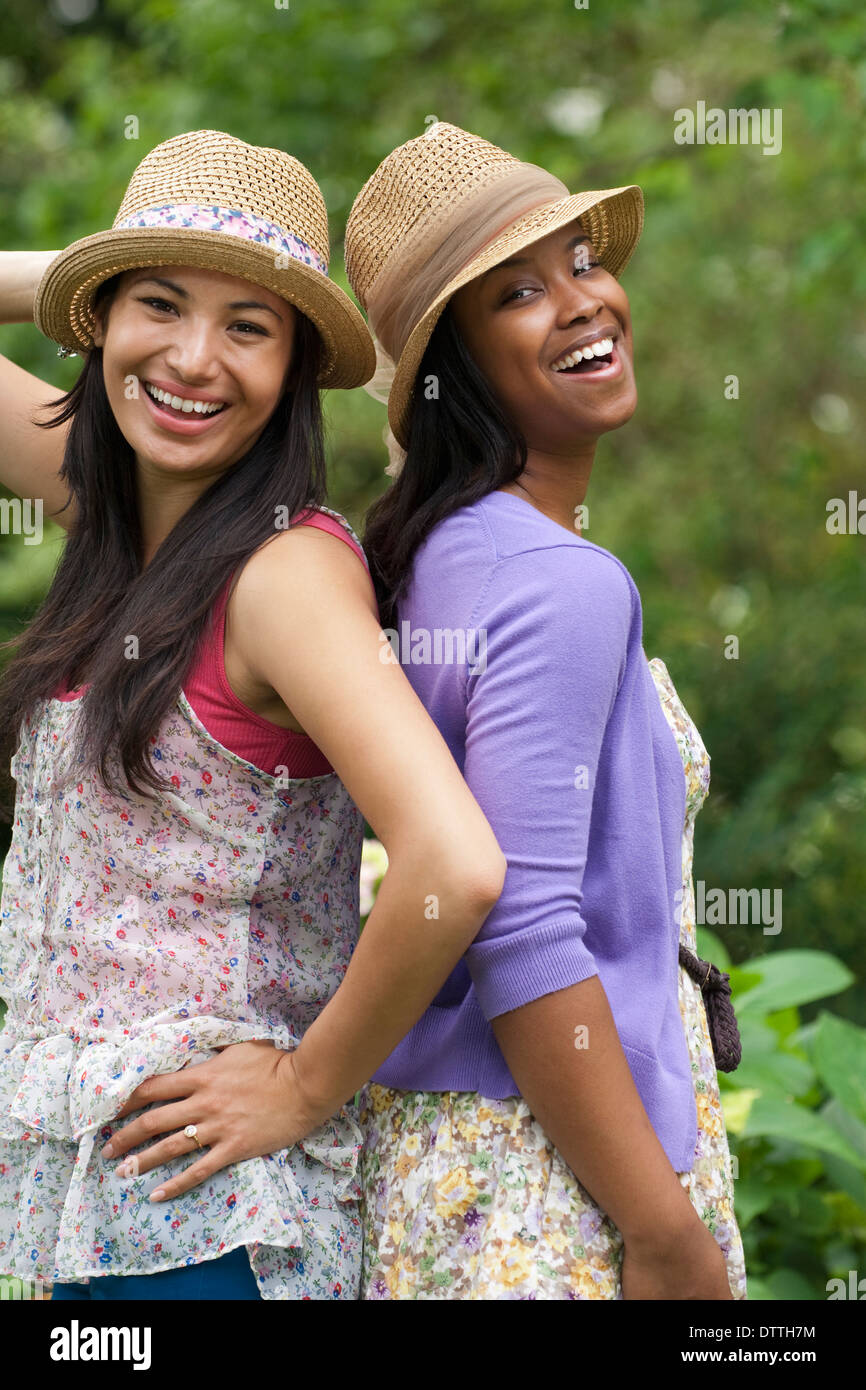 Women standing back to back outdoors Stock Photo - Alamy