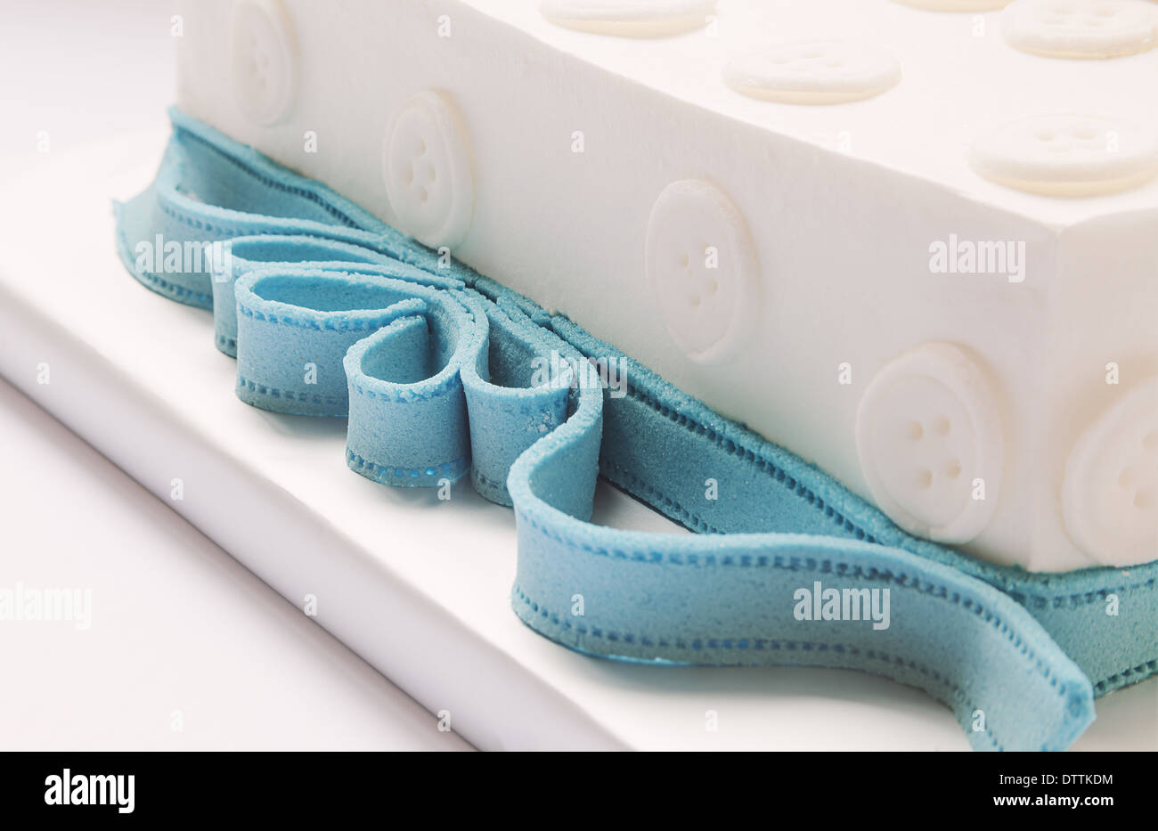 Decoration of a birthday cake, blue ribbon and buttons of sugar as ...