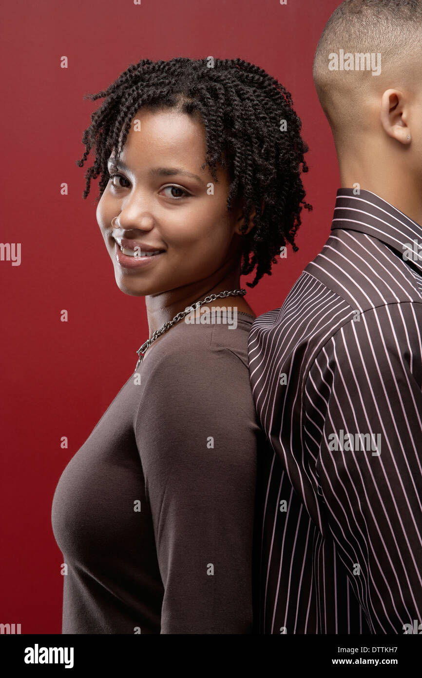 Couple standing back to back Stock Photo - Alamy