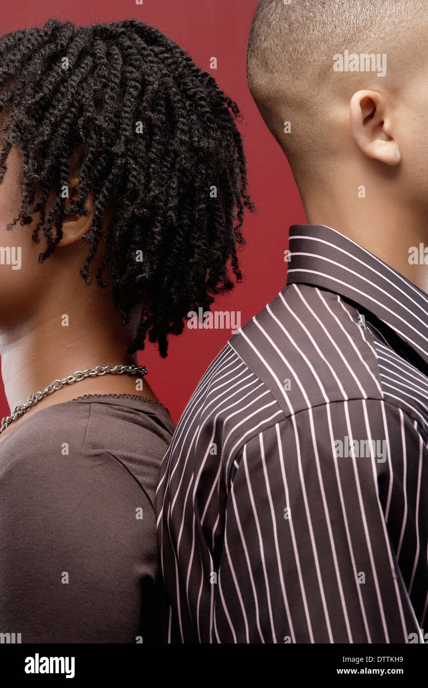 Couple standing back to back Stock Photo - Alamy