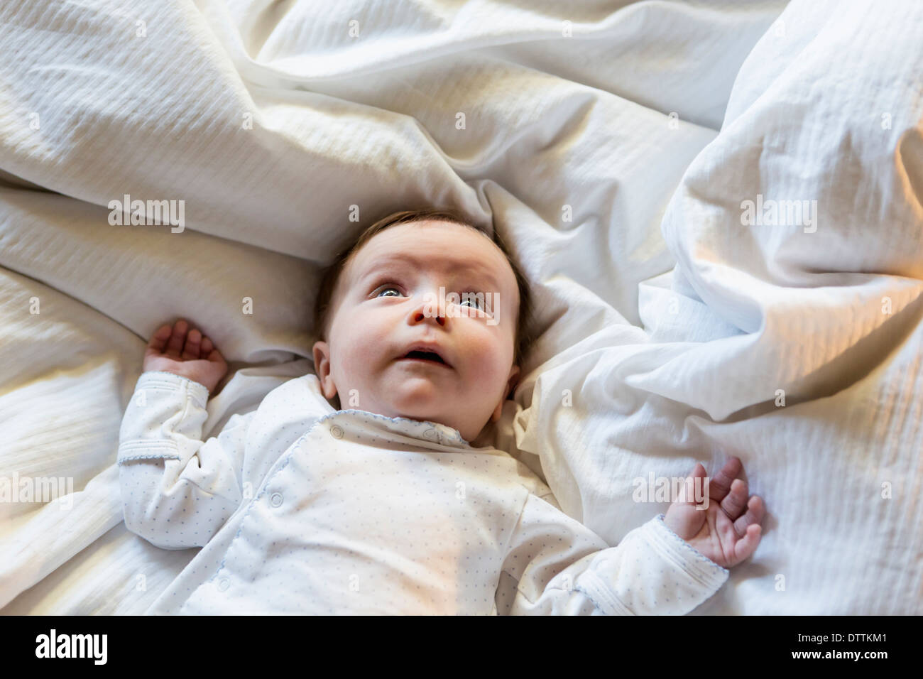 Caucasian baby boy laying in bed Stock Photo - Alamy