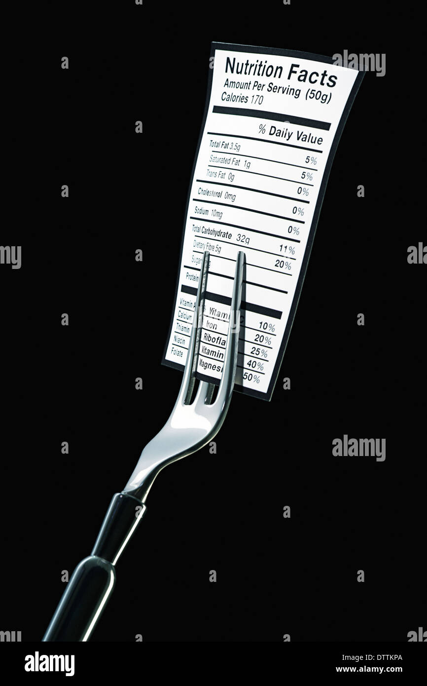 Fork holding nutrition label Stock Photo - Alamy
