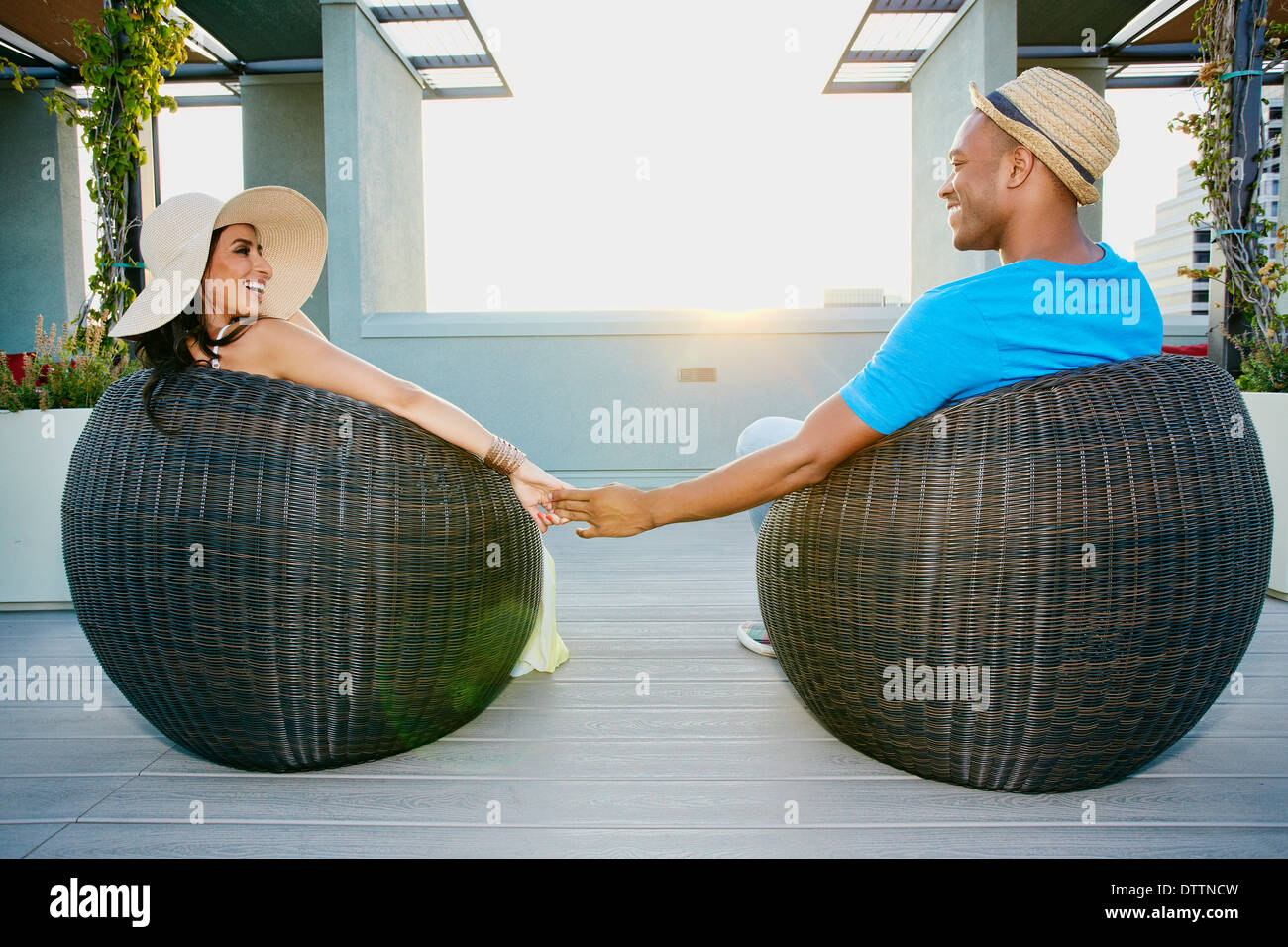 Couple sitting on balcony hi-res stock photography and images - Alamy