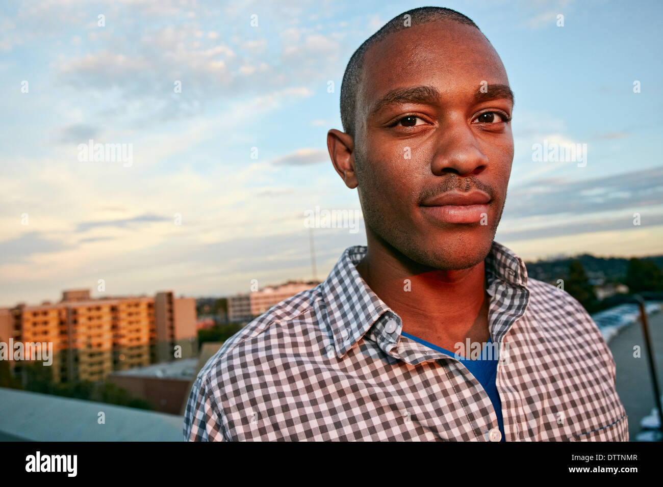 Black man standing on urban rooftop Stock Photo - Alamy