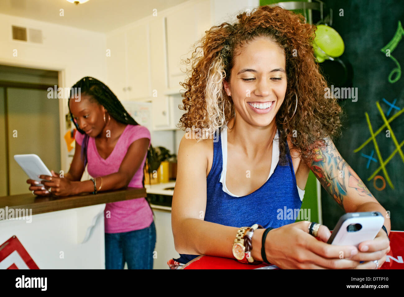 Women using technology in kitchen Stock Photo - Alamy