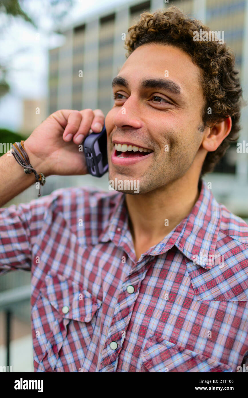 Hispanic man talking on cell phone Stock Photo - Alamy