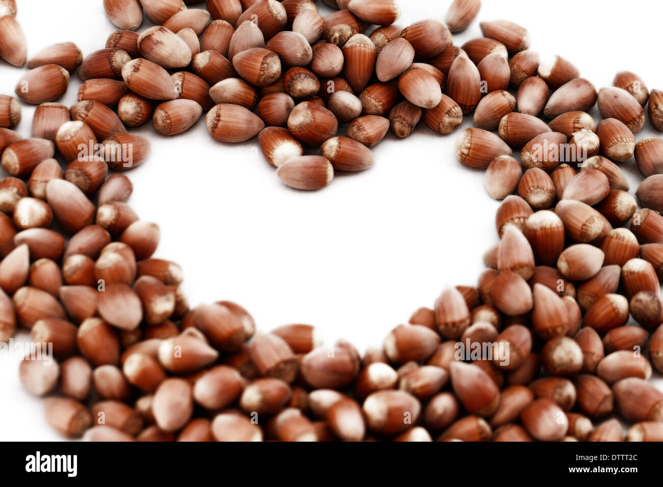 Hazelnut close up isolated (heart background Stock Photo - Alamy
