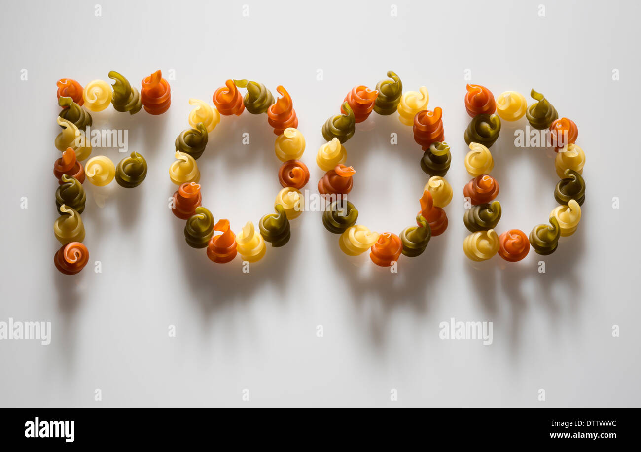 The word food made of red, green and yellow pasta with shadow under ...