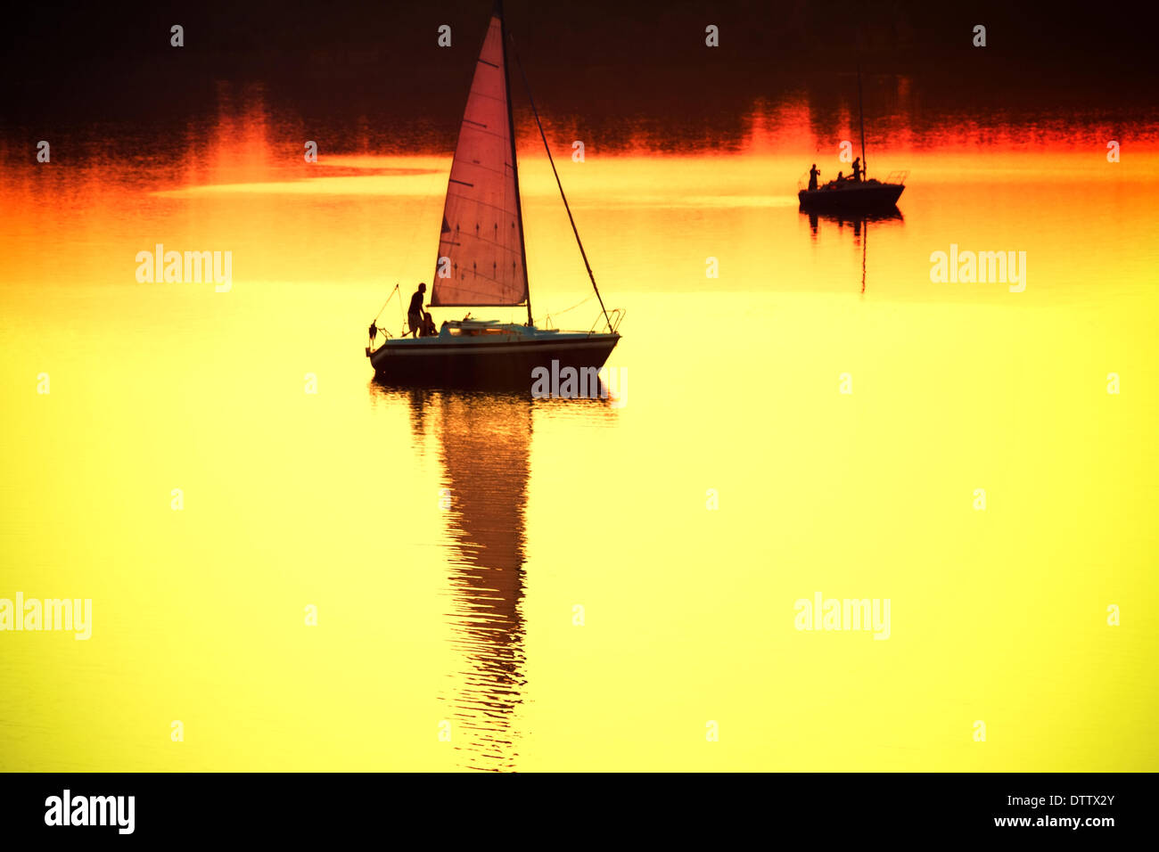 Sailboat at sunset Stock Photo - Alamy