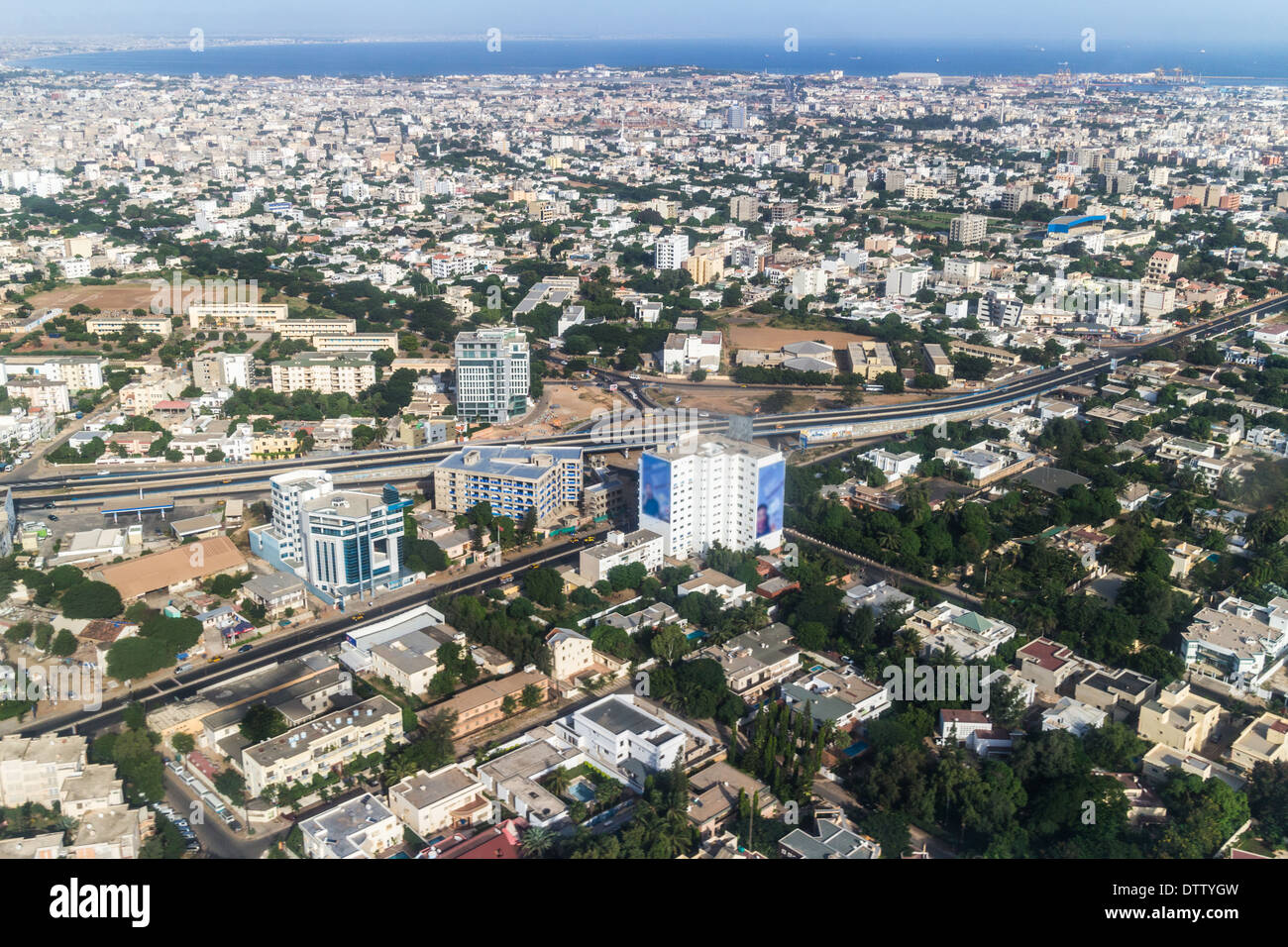Aerial view of the city of Dakar, Senegal, showing the densely packed buildings and a highway ...