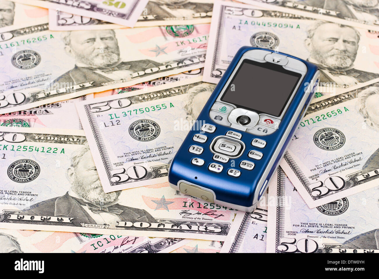 Mobile phone on money background Stock Photo - Alamy