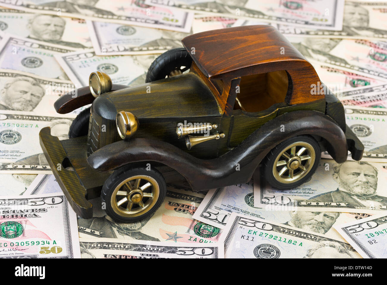Toy retro car on money background Stock Photo - Alamy