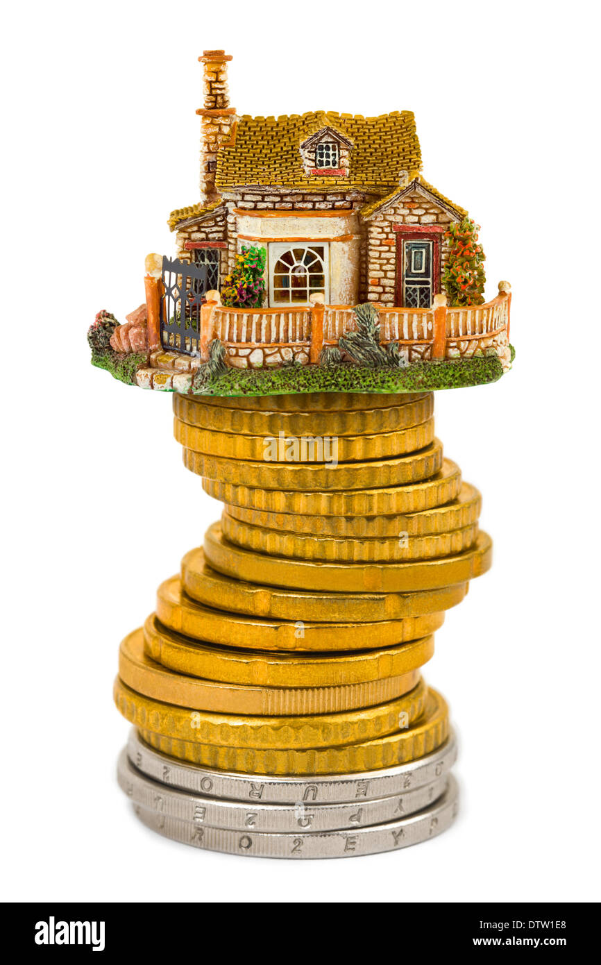 House and stack of coins Stock Photo - Alamy