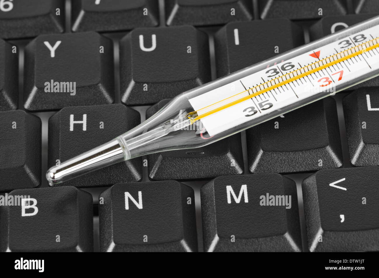 Thermometer on computer keyboard Stock Photo - Alamy