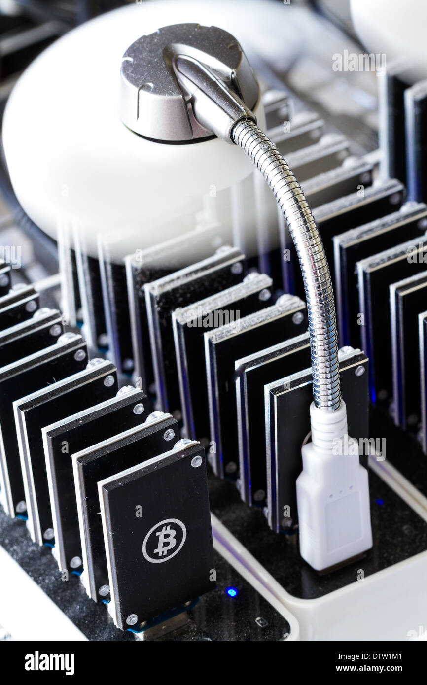 Bitcoin mining USB devices in a row with small fans Stock Photo - Alamy