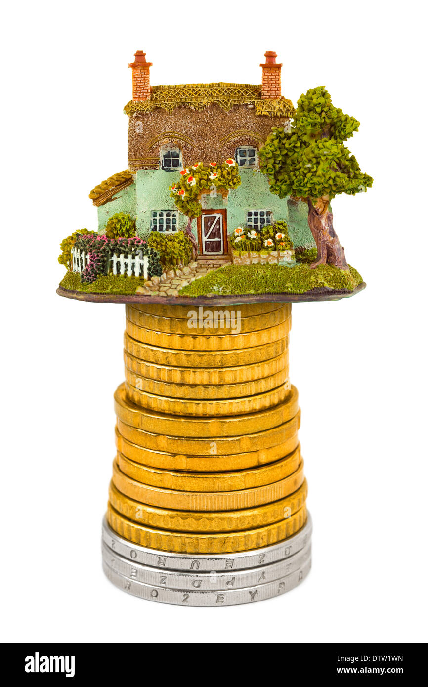 House and stack of coins Stock Photo - Alamy