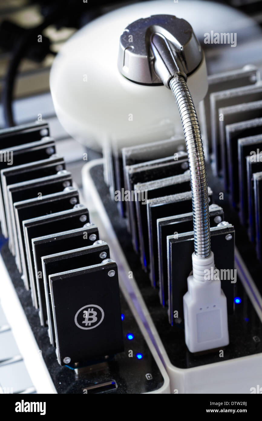 Bitcoin mining USB devices in a row with small fans Stock Photo - Alamy