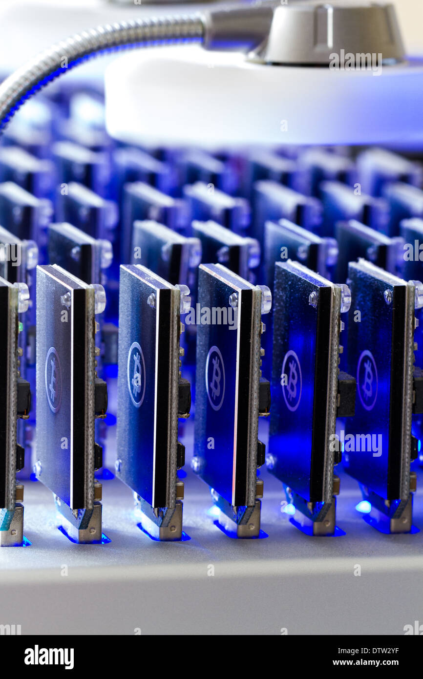 Bitcoin mining USB devices in a row with small fans Stock Photo - Alamy