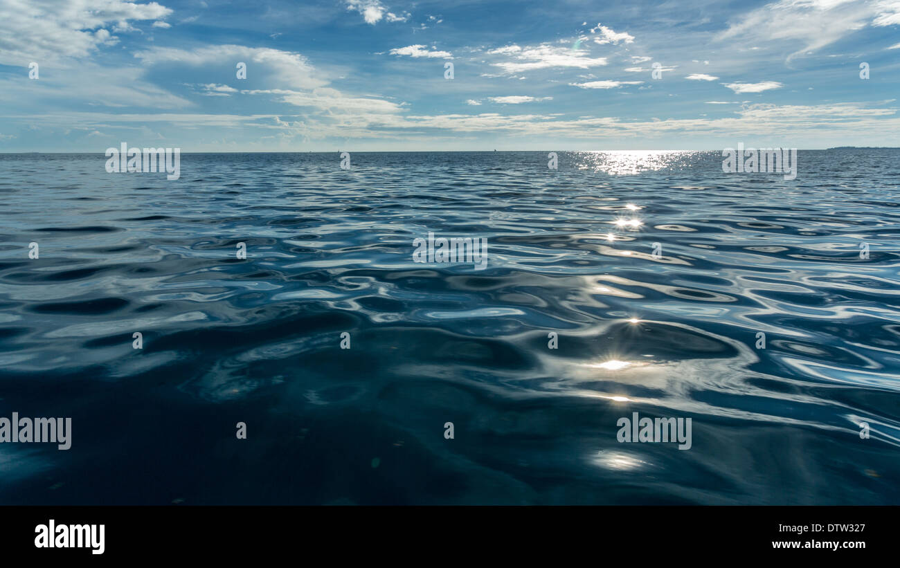 The late afternoon sun reflecting on the dark blue water of the Indian ...