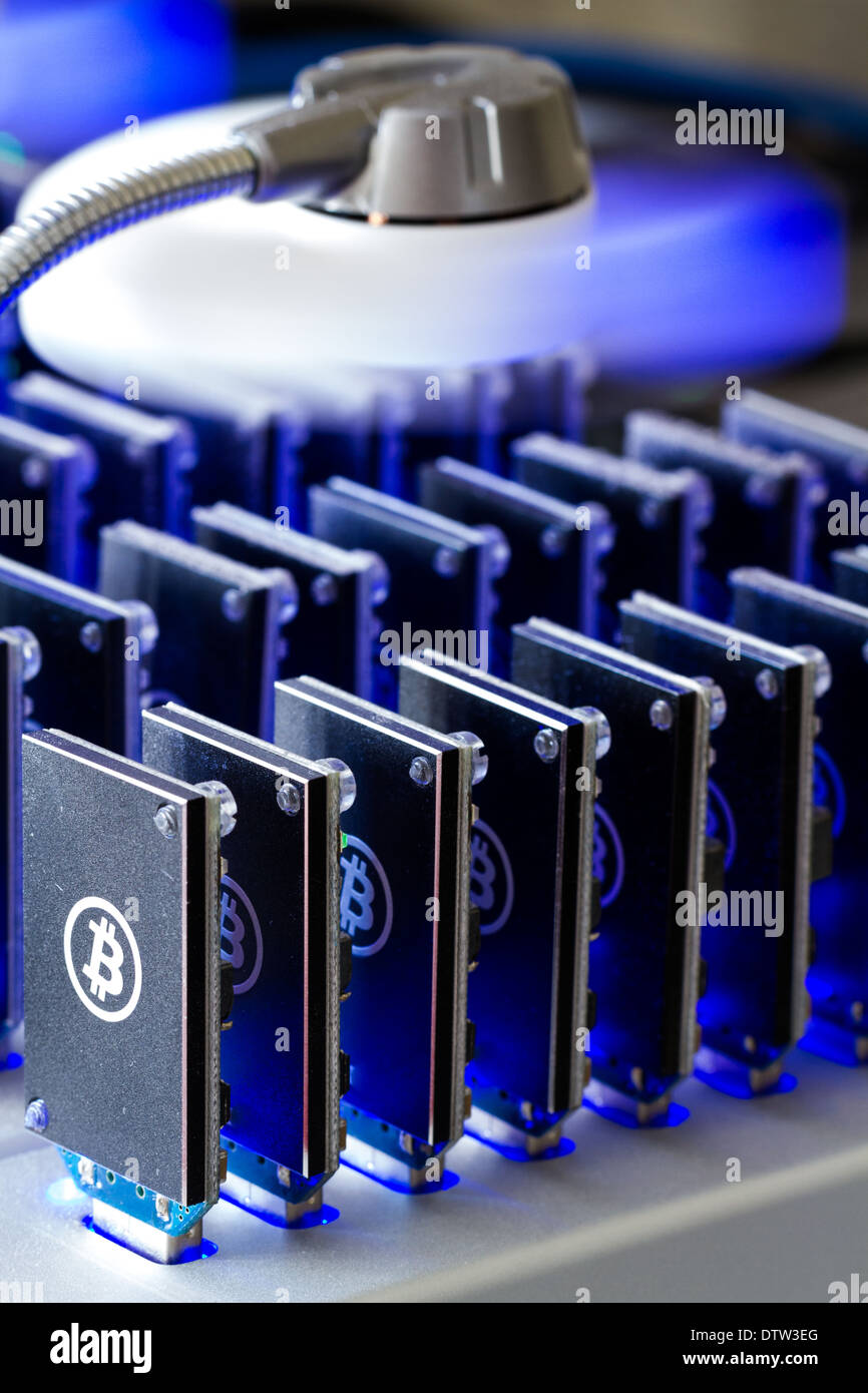 Bitcoin mining USB devices in a row with small fans Stock Photo - Alamy