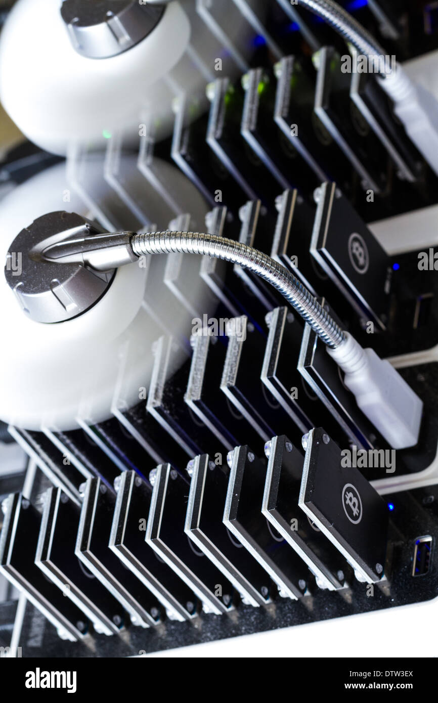 Bitcoin mining USB devices in a row with small fans Stock Photo - Alamy