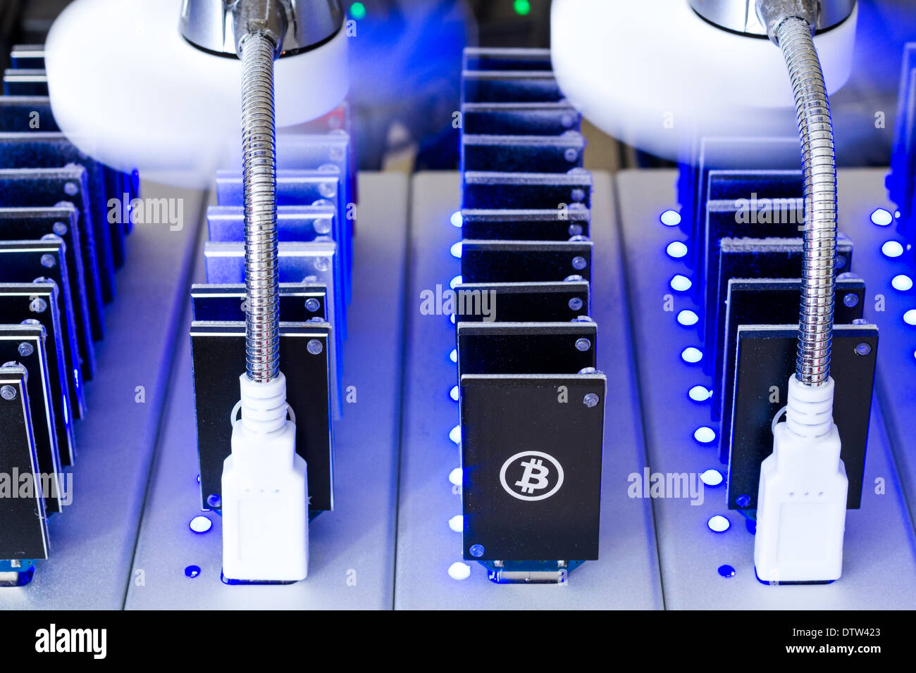 Bitcoin mining USB devices in a row with small fans Stock Photo - Alamy