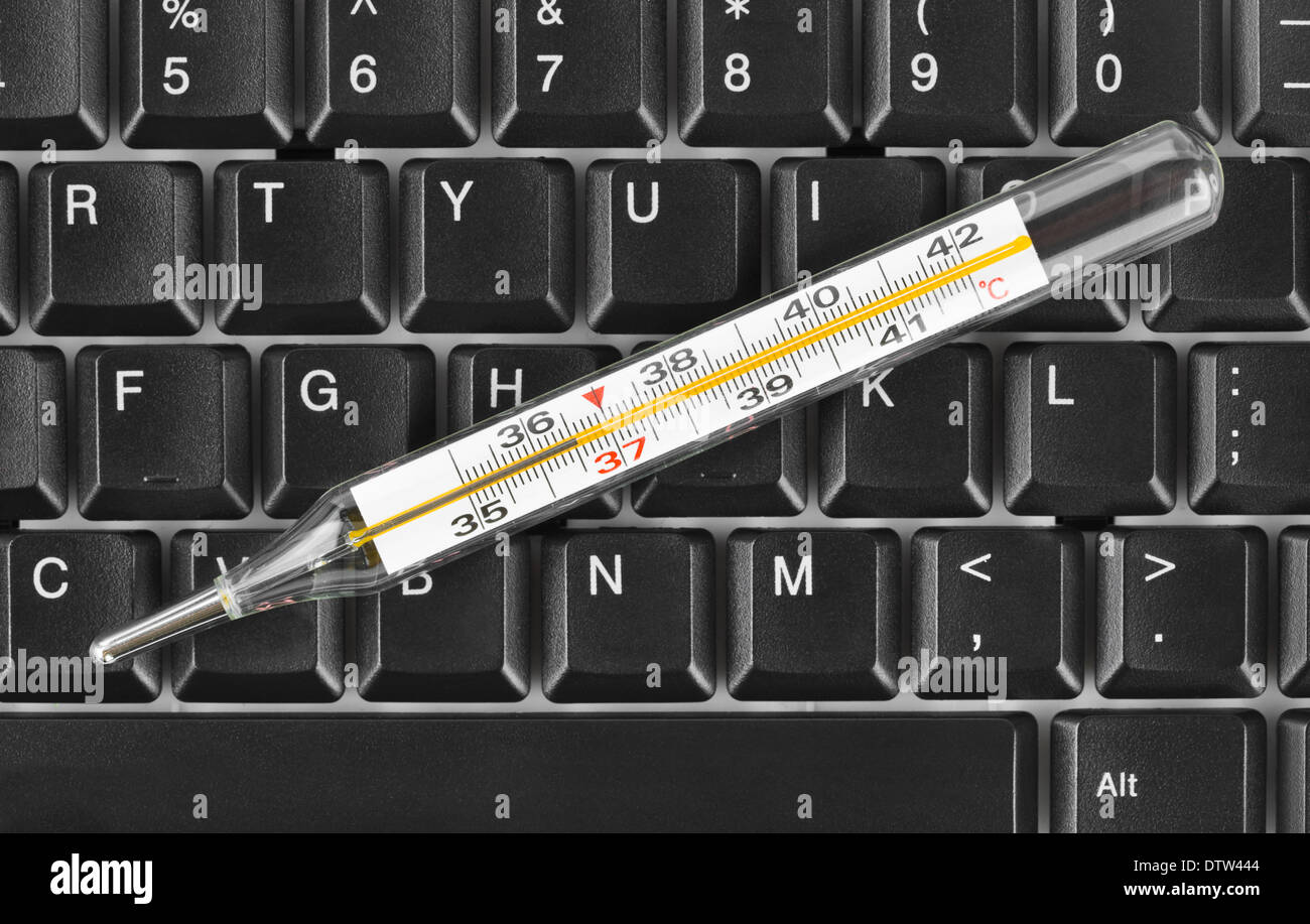 Thermometer on computer keyboard Stock Photo - Alamy