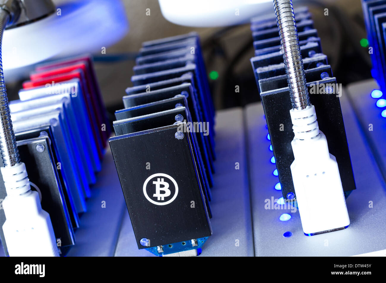 Bitcoin mining USB devices in a row with small fans Stock Photo - Alamy