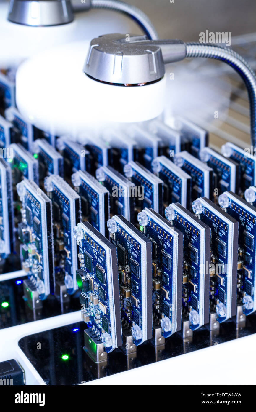 Bitcoin mining USB devices in a row with small fans Stock Photo - Alamy