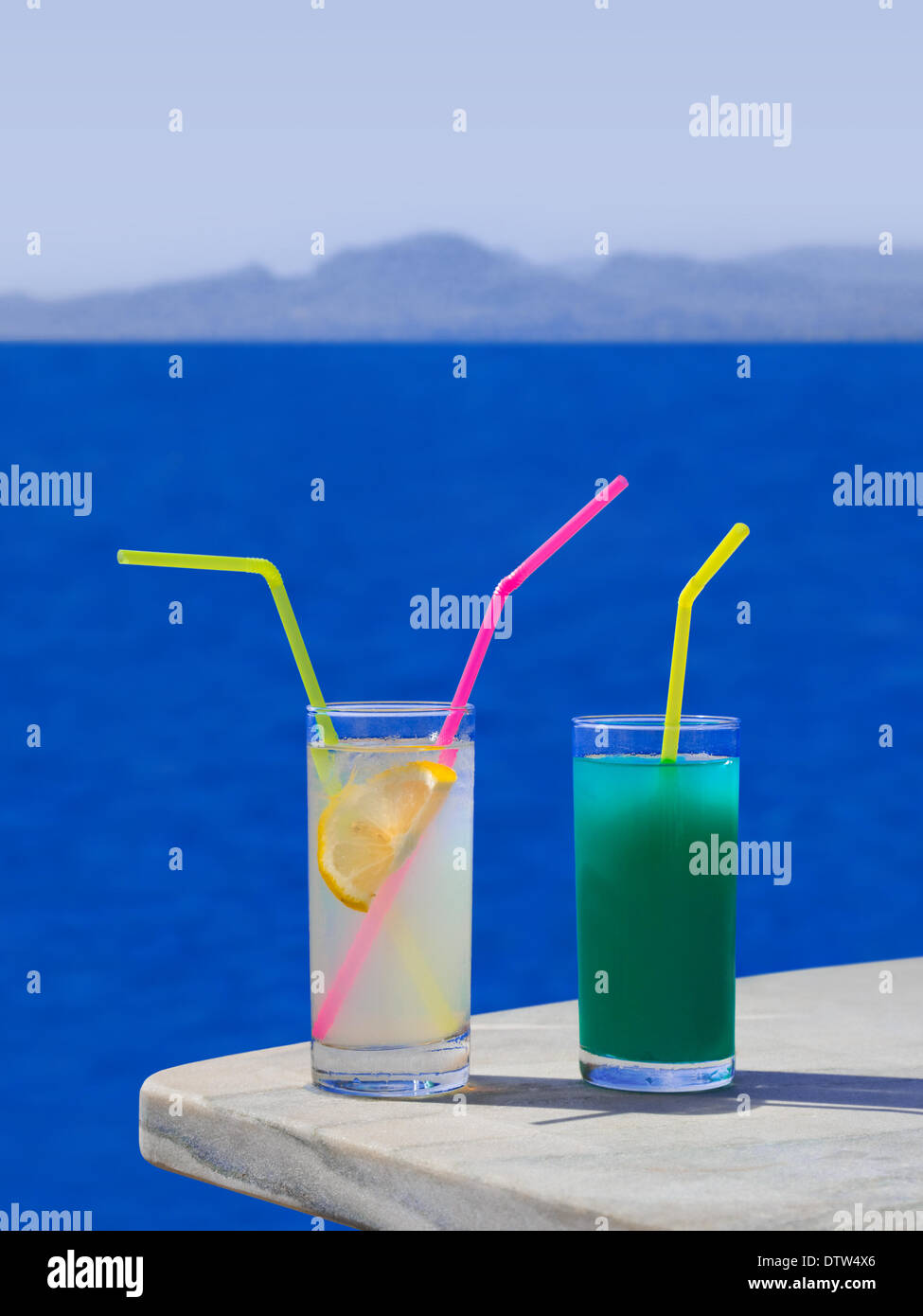 Two cocktails on table at beach Stock Photo - Alamy