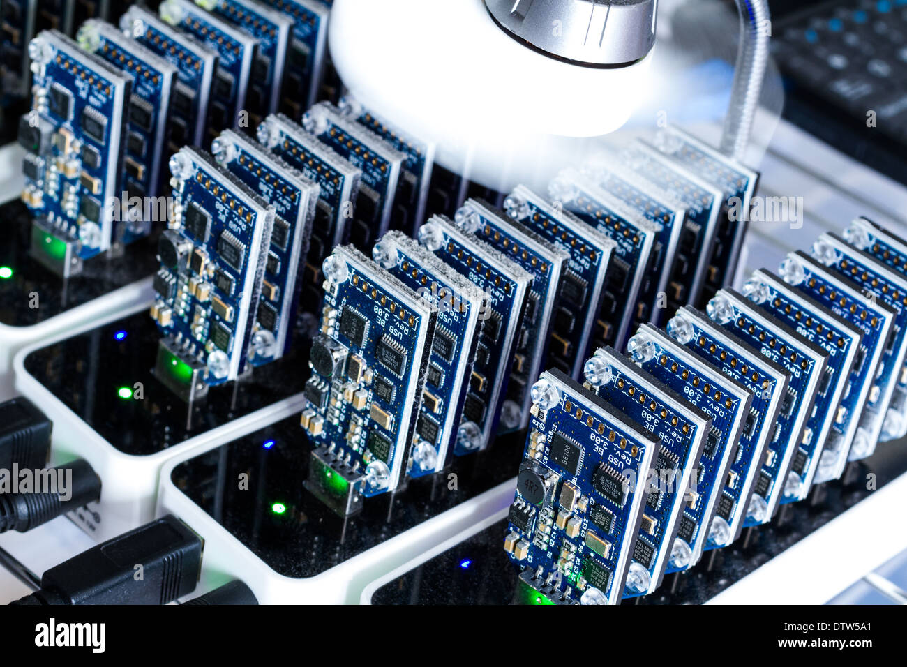 Bitcoin mining USB devices in a row with small fans Stock Photo - Alamy