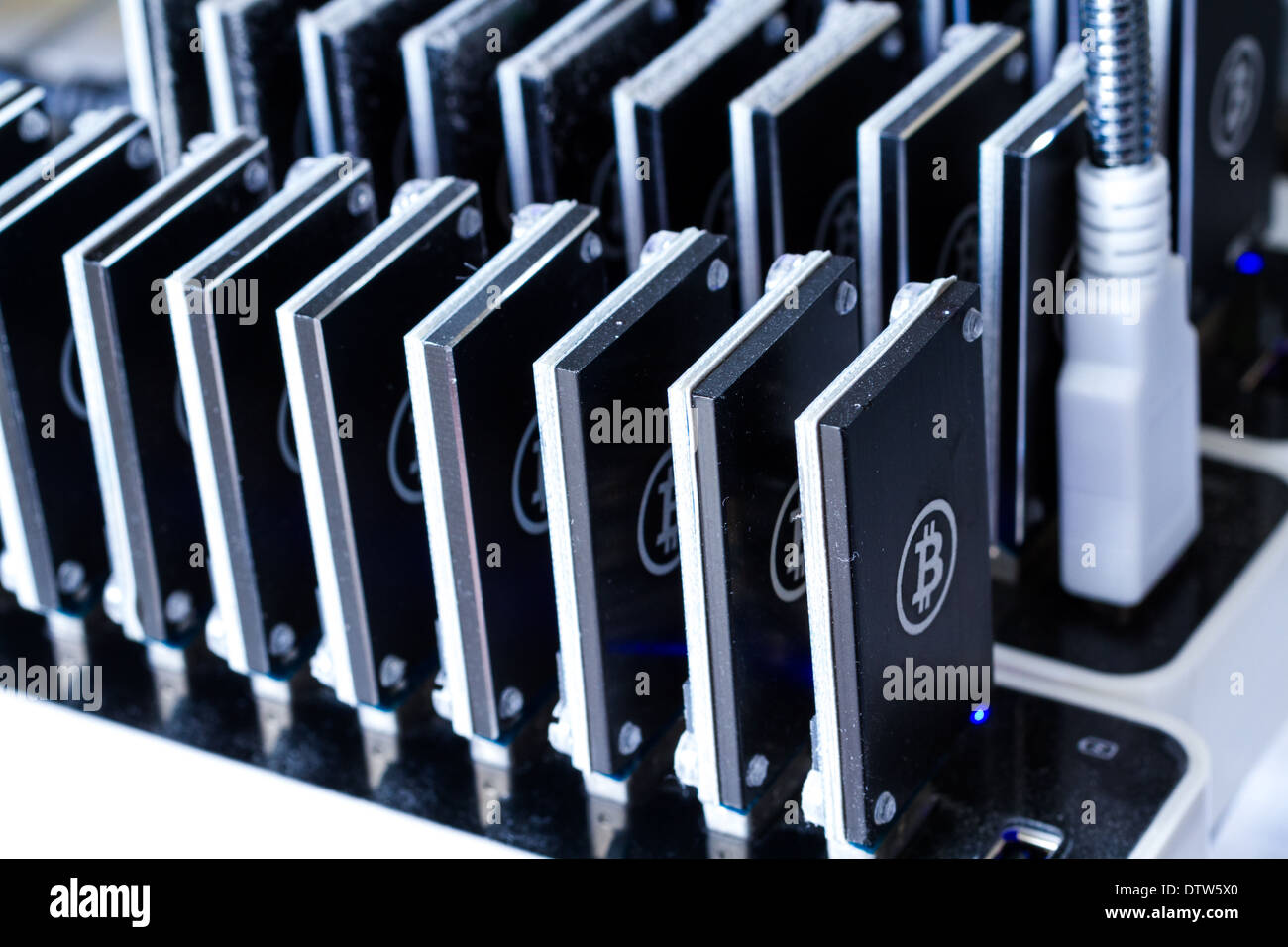 Bitcoin mining USB devices in a row with small fans Stock Photo - Alamy