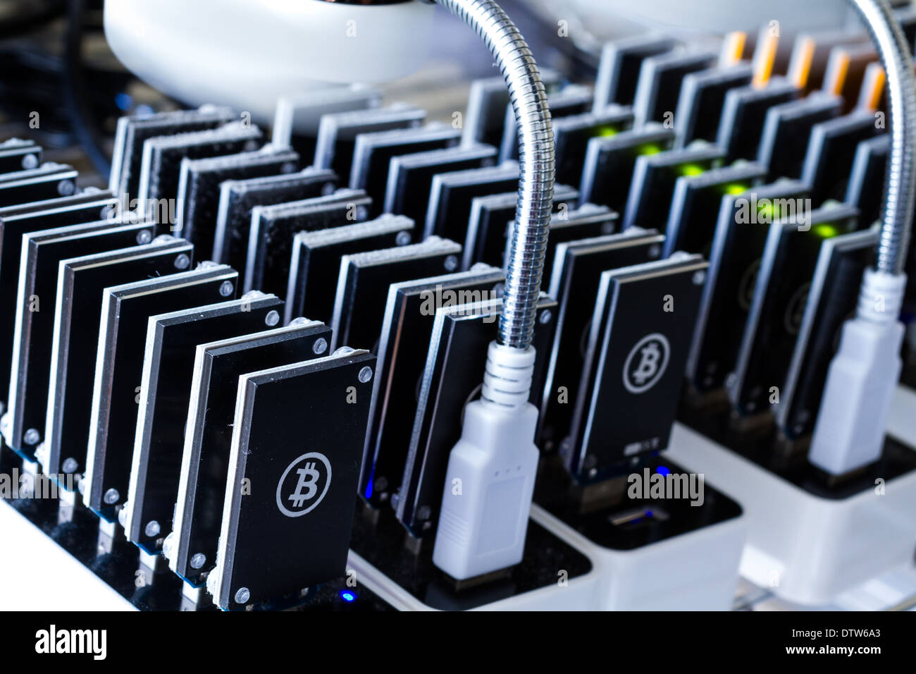 Bitcoin mining USB devices in a row with small fans Stock Photo - Alamy