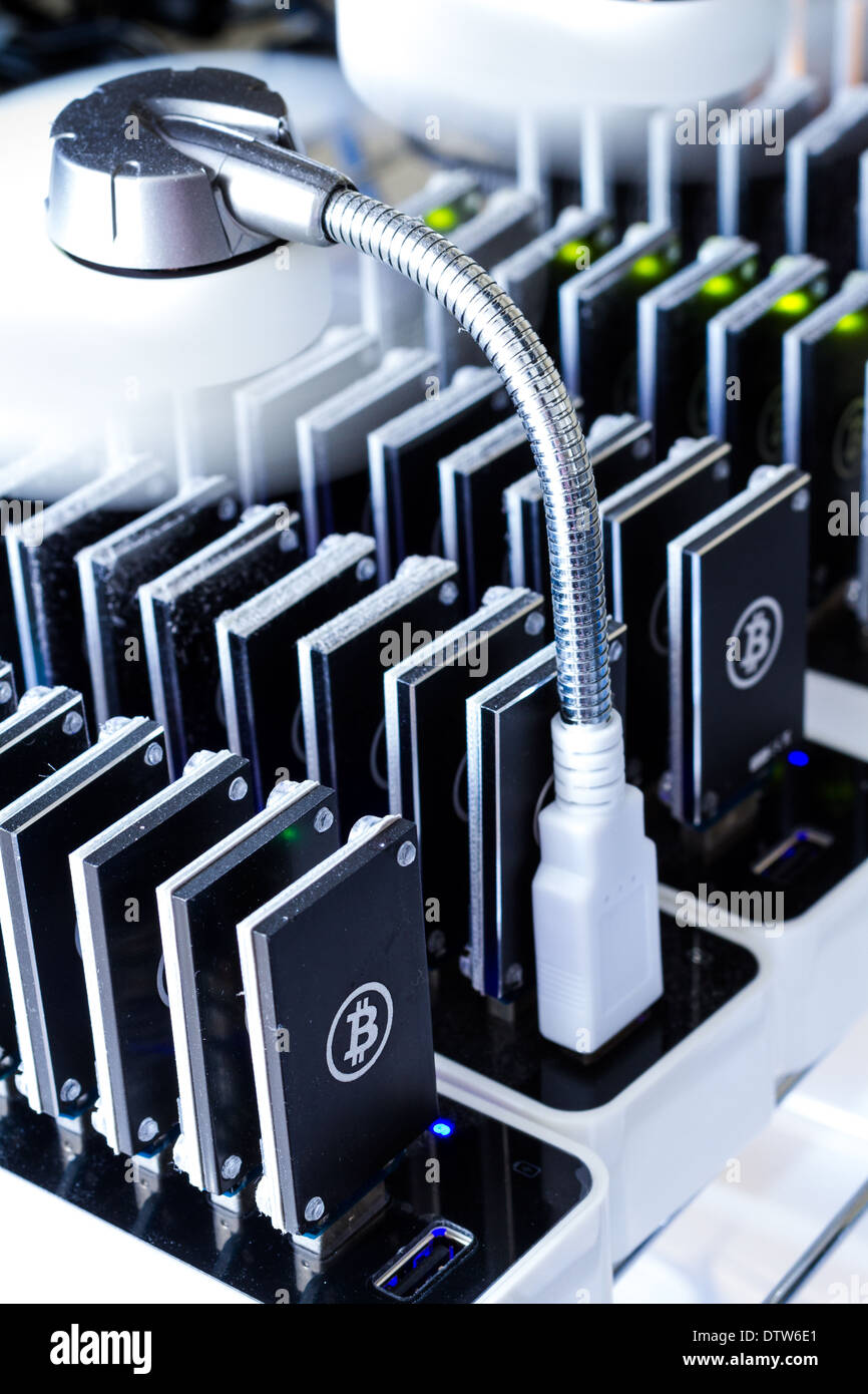 Bitcoin mining USB devices in a row with small fans Stock Photo - Alamy
