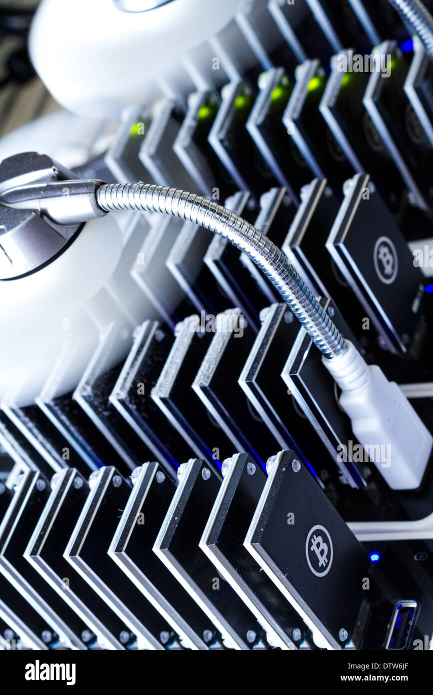Bitcoin mining USB devices in a row with small fans Stock Photo - Alamy