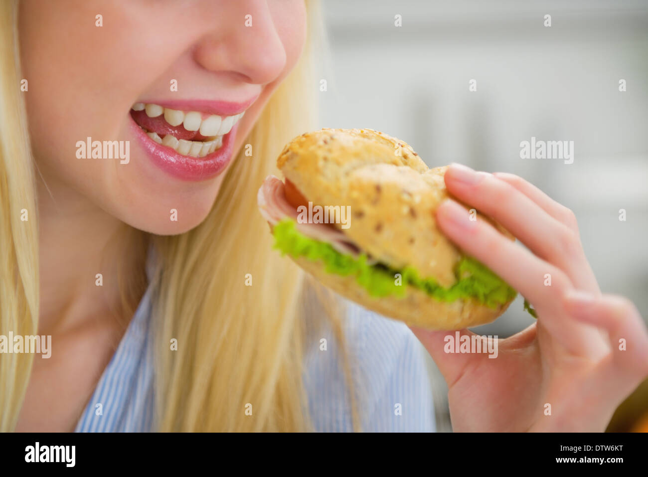 Closeup on young woman eating sandwich Stock Photo - Alamy