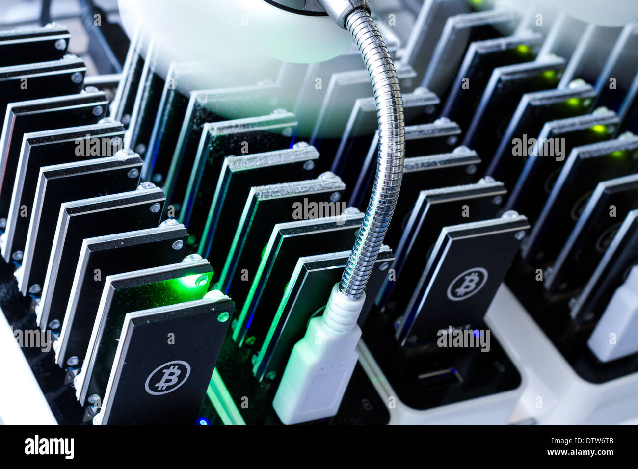 Bitcoin mining USB devices in a row with small fans Stock Photo - Alamy