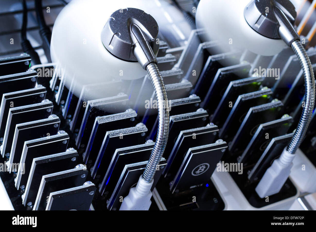 Bitcoin mining USB devices in a row with small fans Stock Photo - Alamy