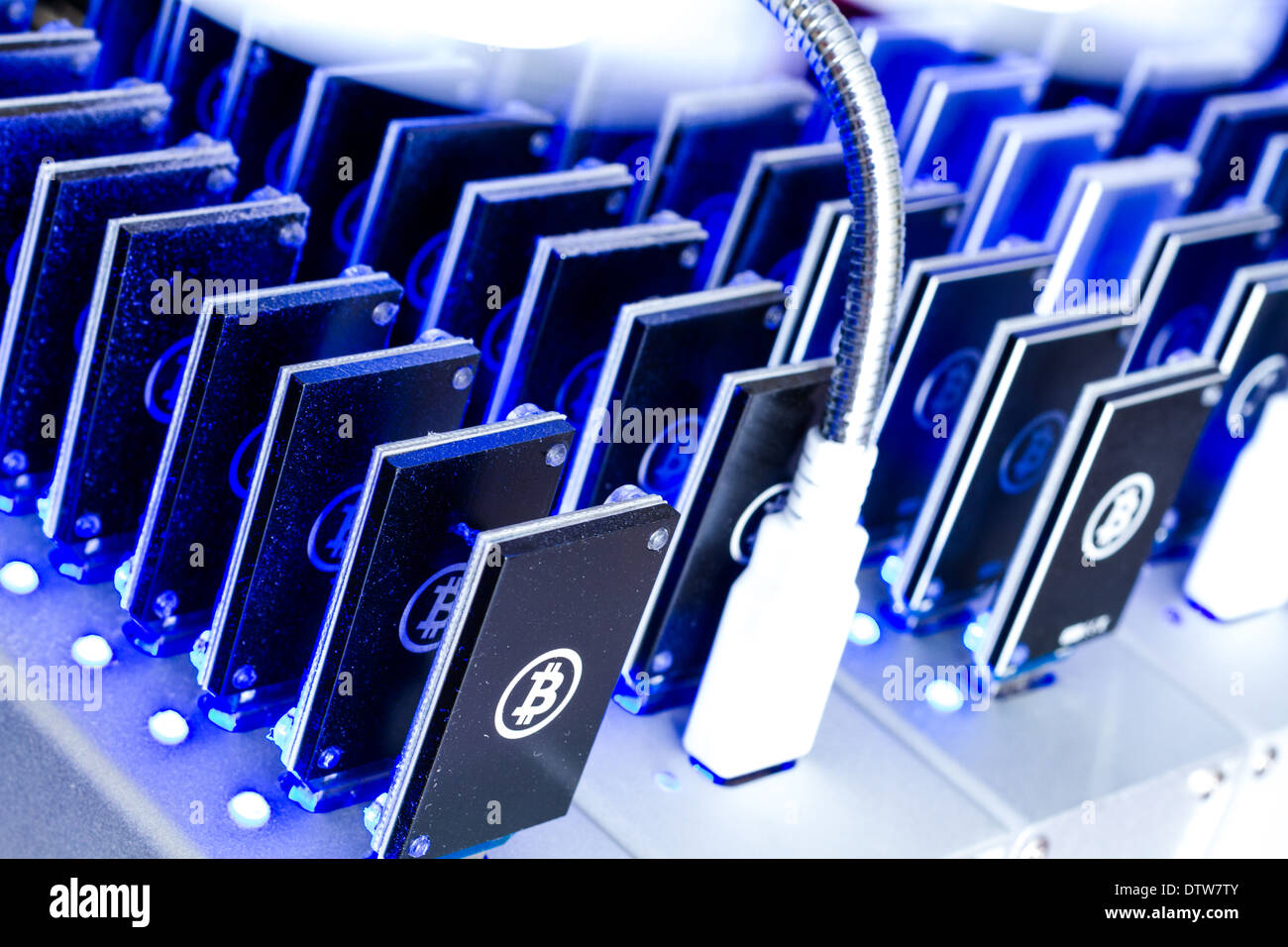 Bitcoin mining USB devices in a row with small fans Stock Photo - Alamy