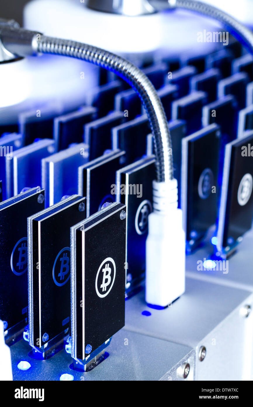 Bitcoin mining USB devices in a row with small fans Stock Photo - Alamy