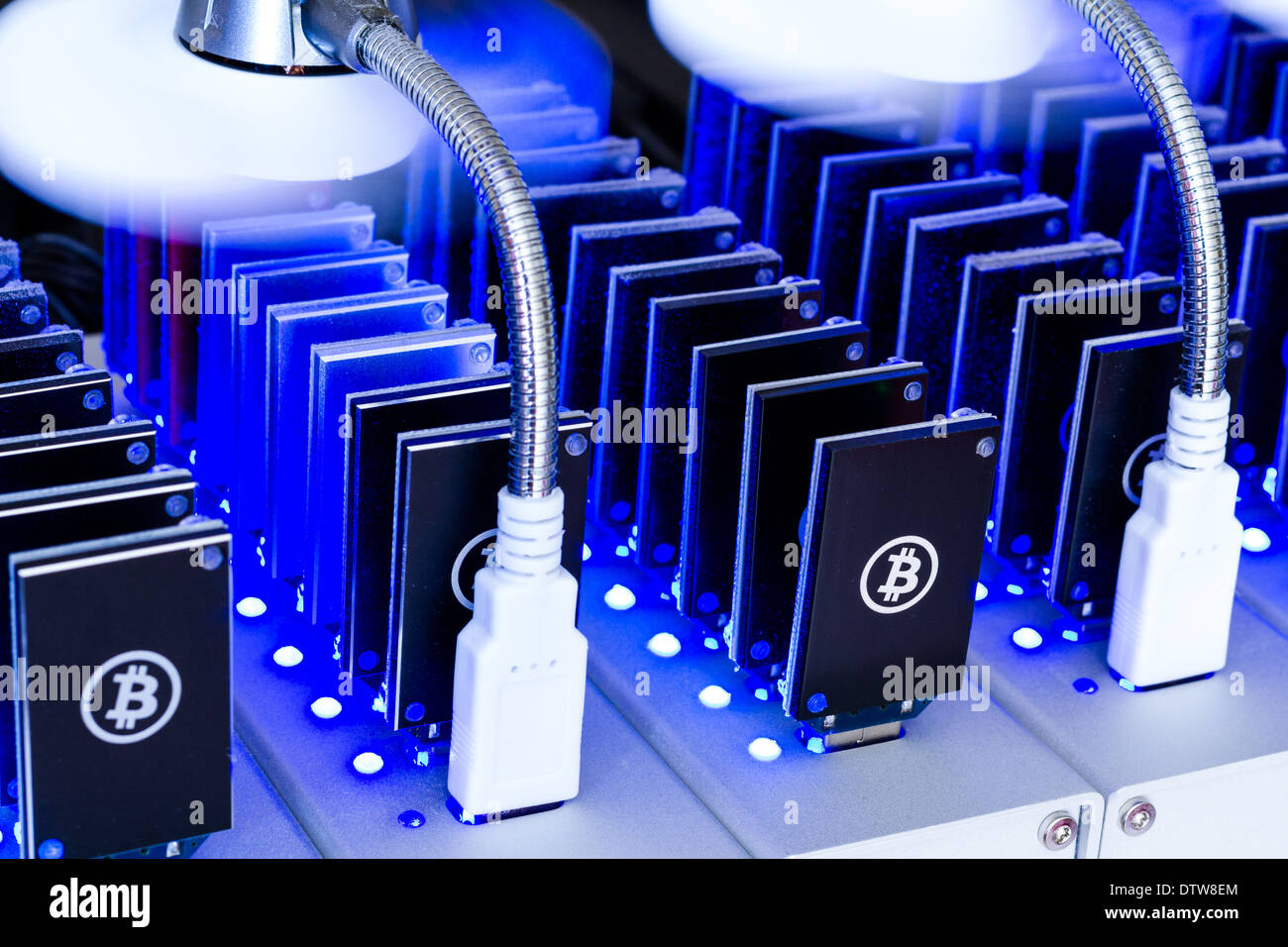 Bitcoin mining USB devices in a row with small fans Stock Photo - Alamy