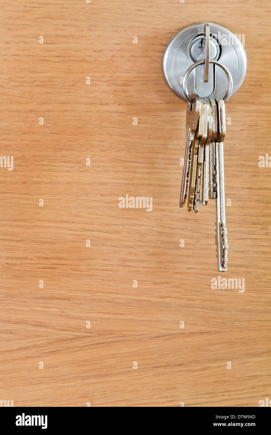 bunch of home keys in lock of wood door close up Stock Photo - Alamy