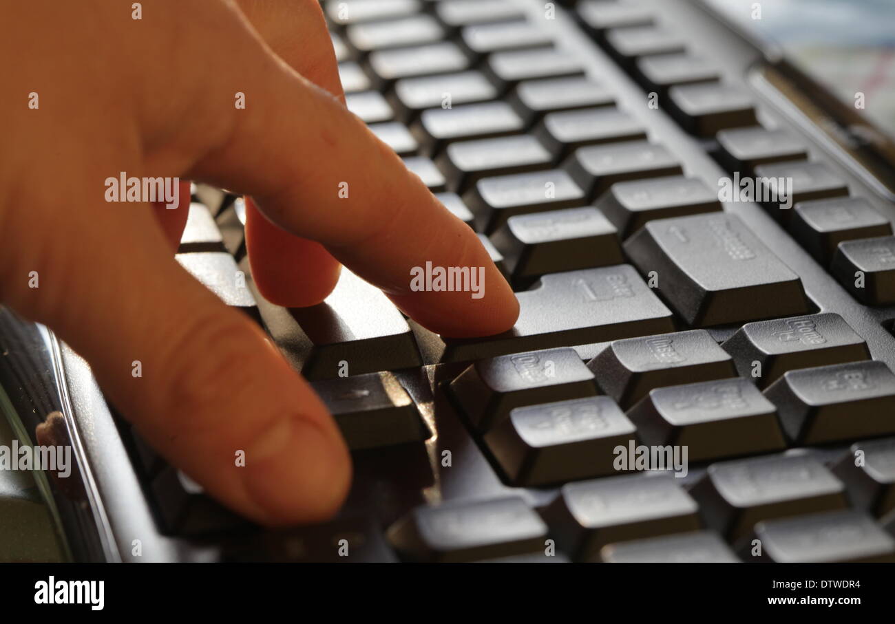 Finger on keyboard Stock Photo - Alamy