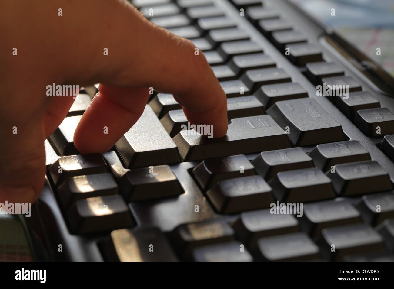 Finger on keyboard Stock Photo - Alamy